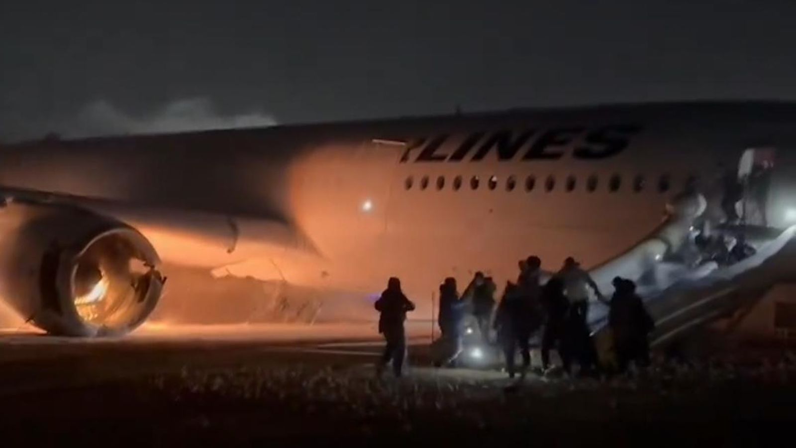 Japan: Moment passengers evacuate burning plane at Tokyo airport after ...