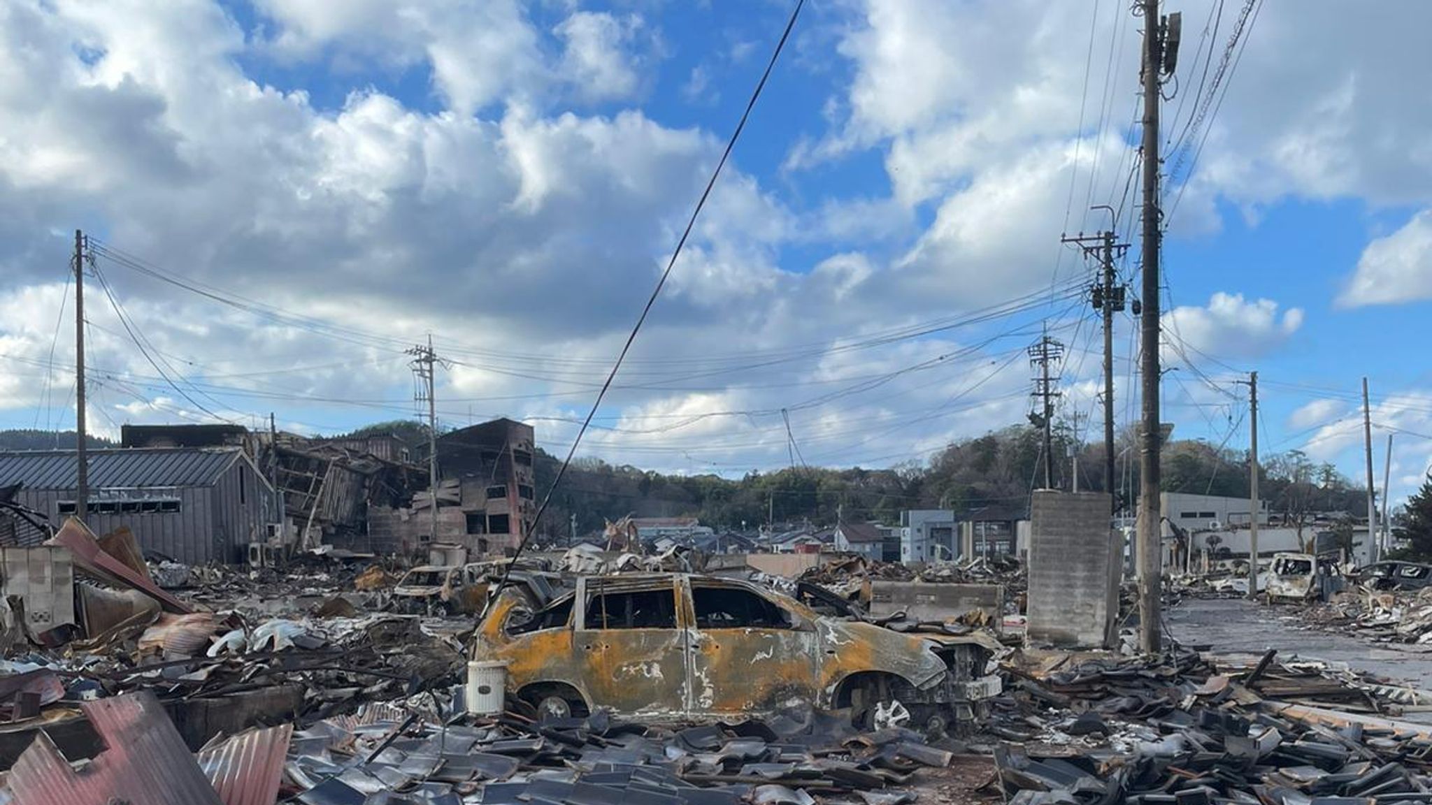 Japan earthquake: Trapped woman pulled to safety from rubble after ...