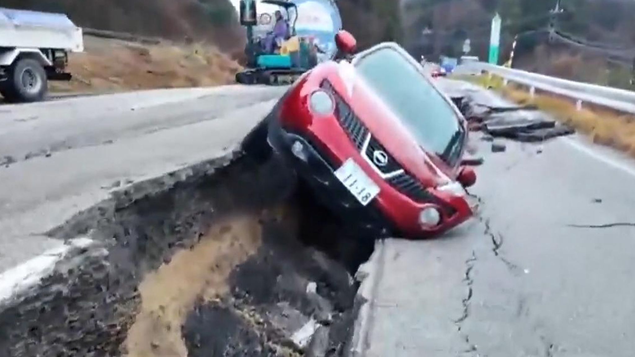Japan earthquake: Trapped woman pulled to safety from rubble after ...