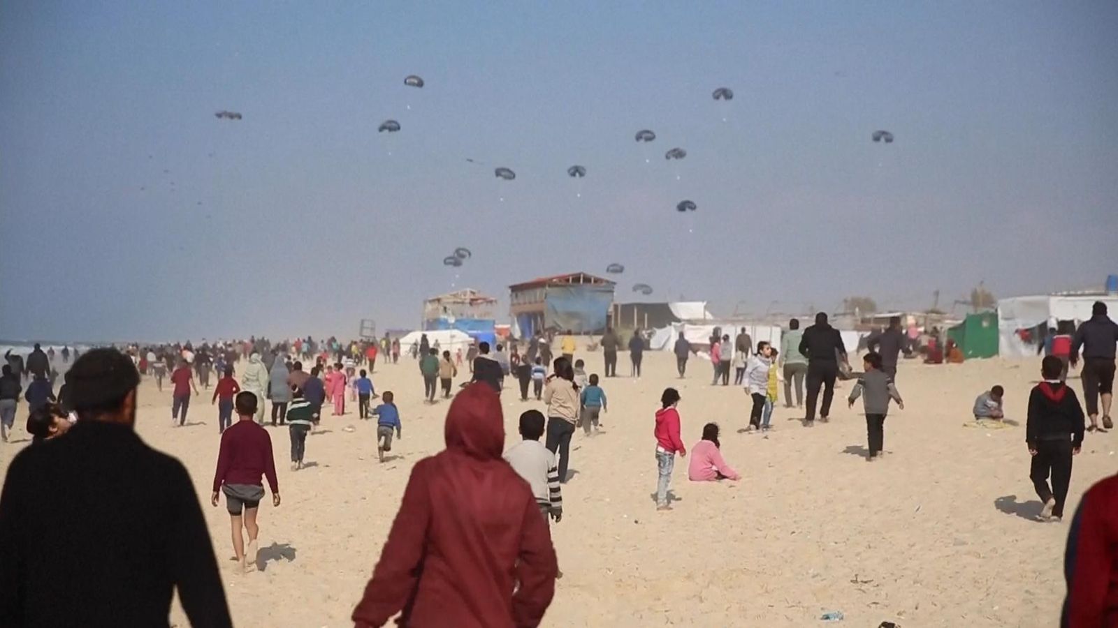 Palestinians scramble for airdropped aid in Gaza | World News | Sky News