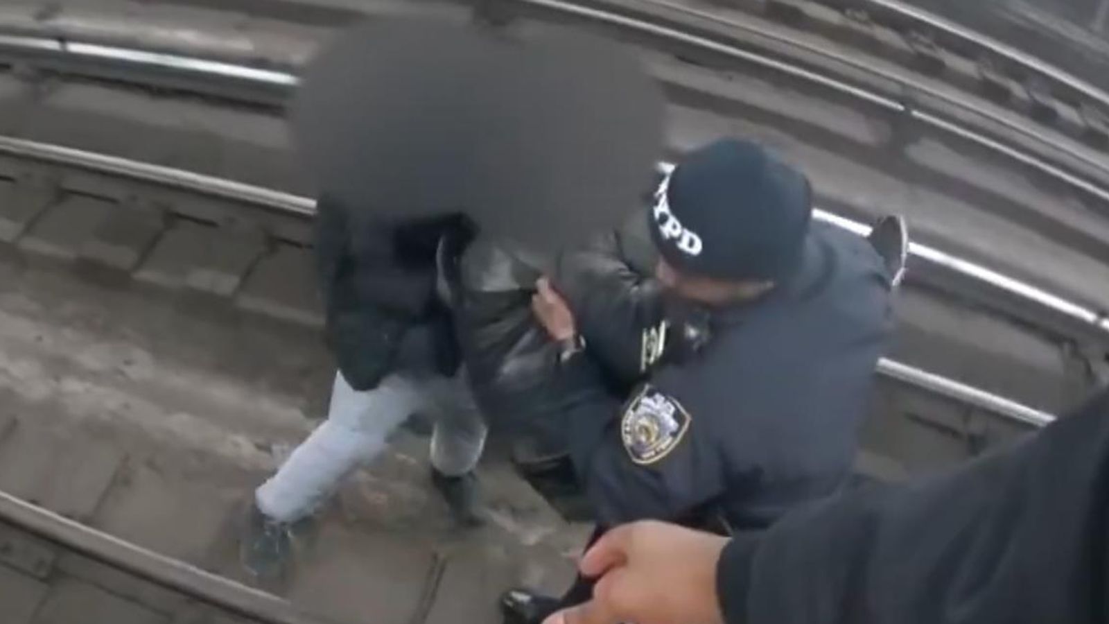 US: Police officers and a commuter jumped into action when a man fell onto the subway tracks in ...