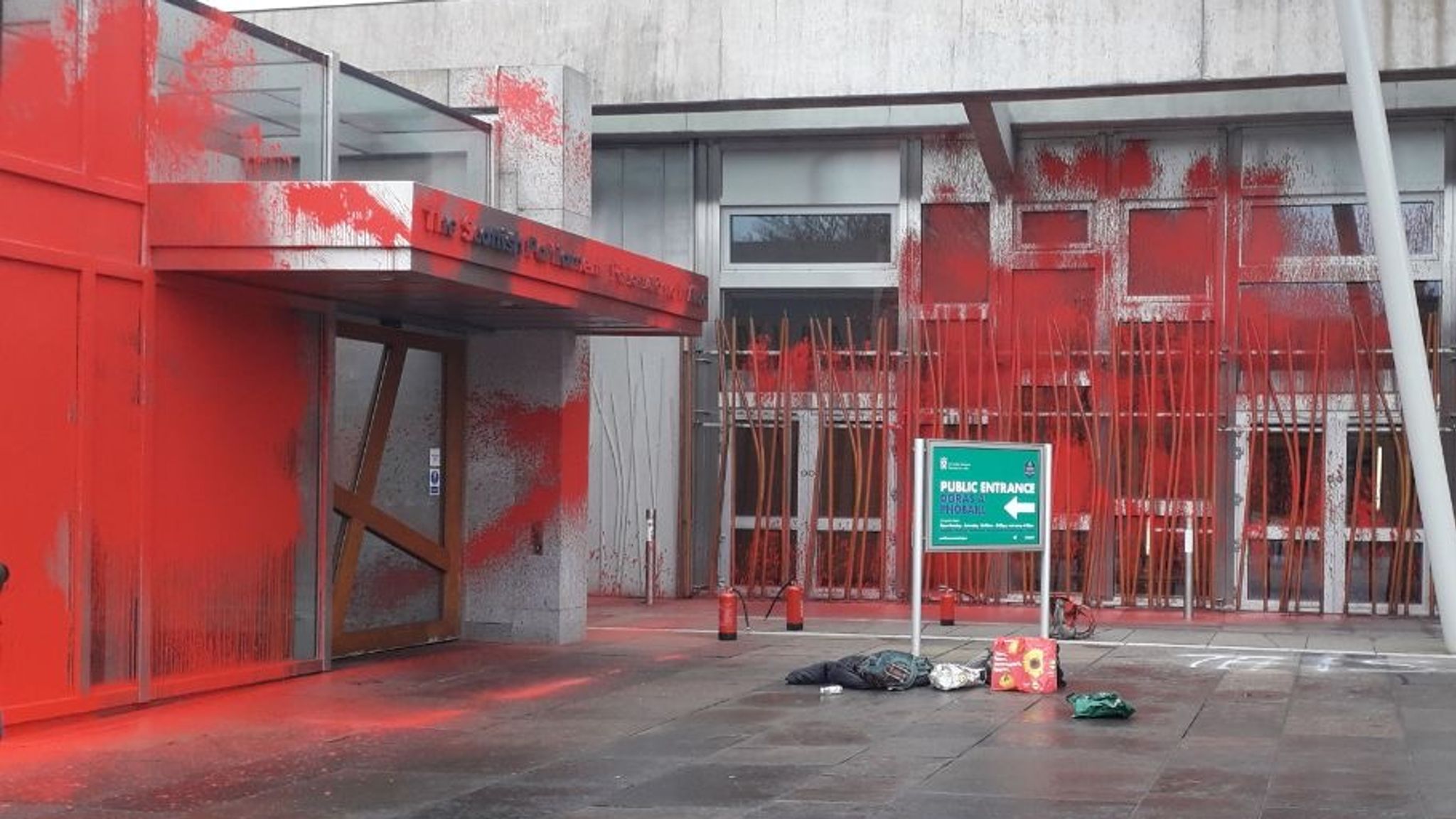 Three people arrested as red paint sprayed on Scottish Parliament in ...