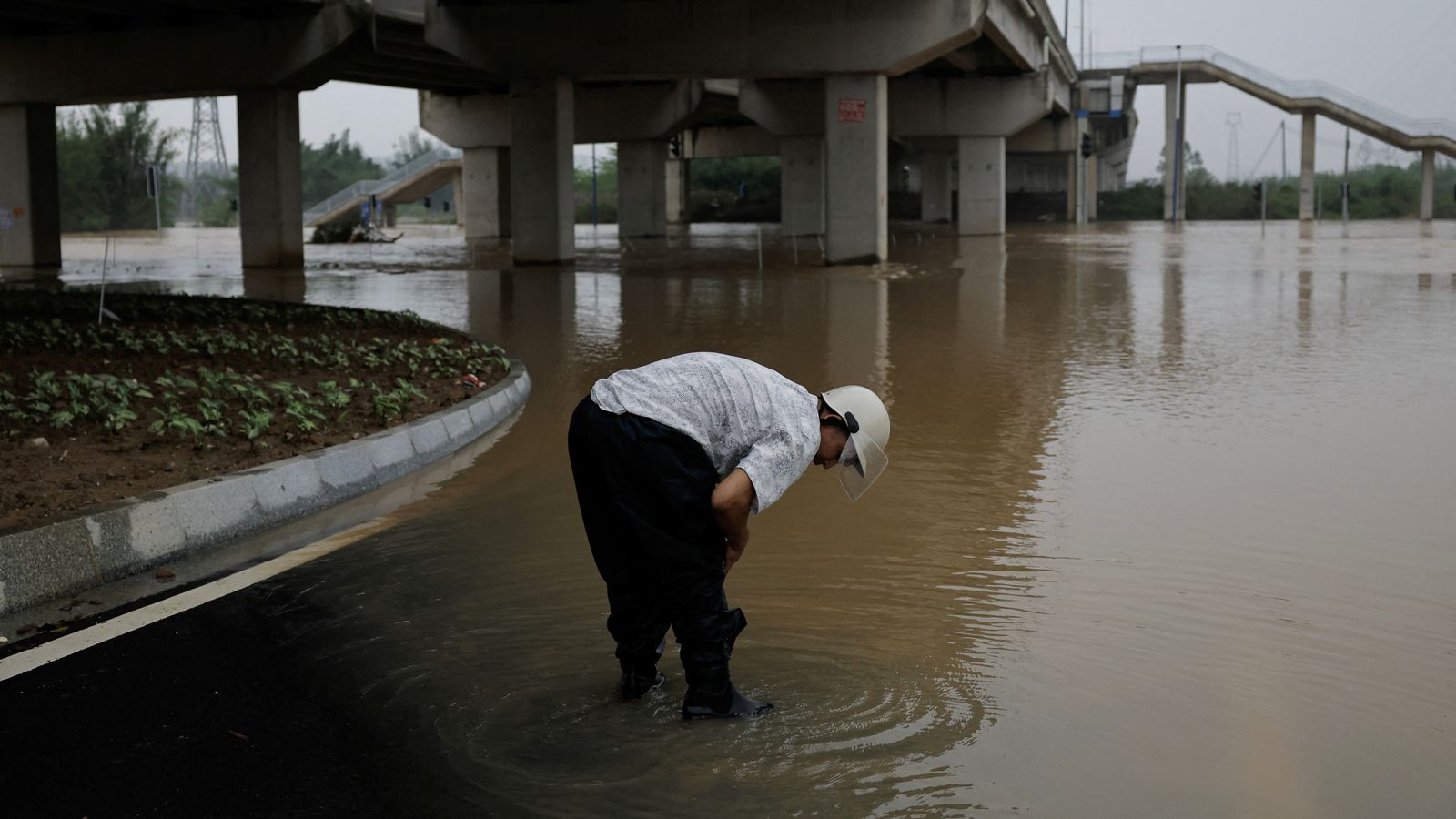 China floods: Four dead as cities submerged after days of record ...