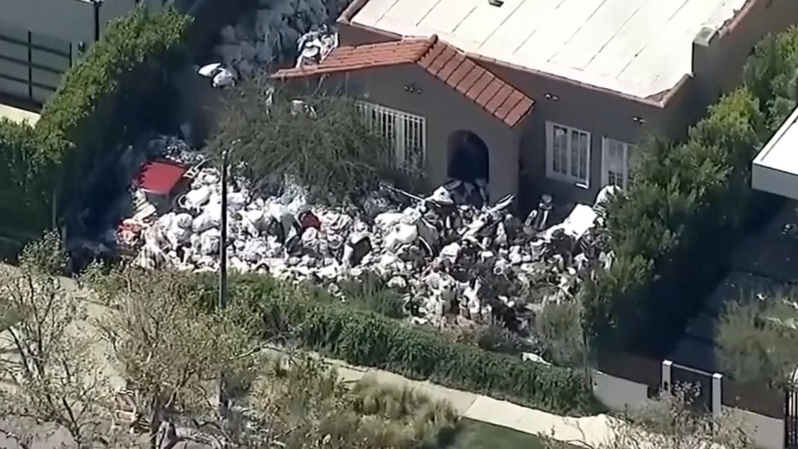 LA: 'Trash house' where a decade worth of rubbish litters the garden | US News | Sky News