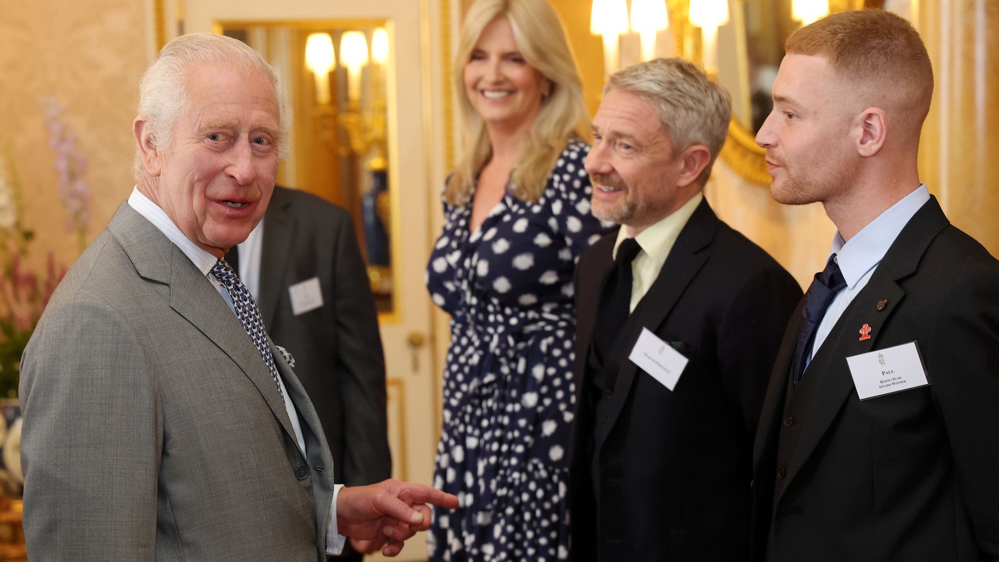 The King breaks convention with a fist bump at Buckingham Palace, while ...