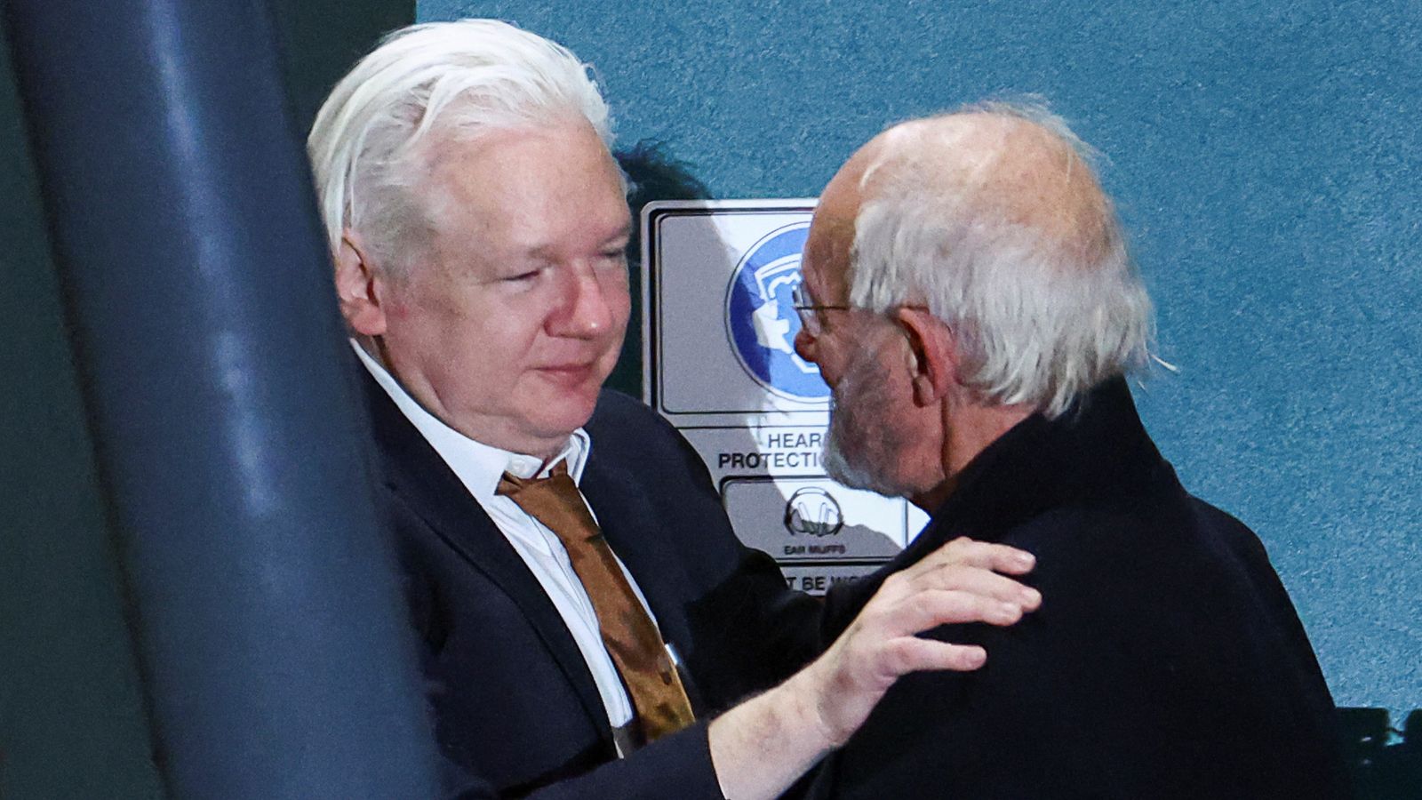 Julian Assange passionately kisses wife and waves to supporters after ...