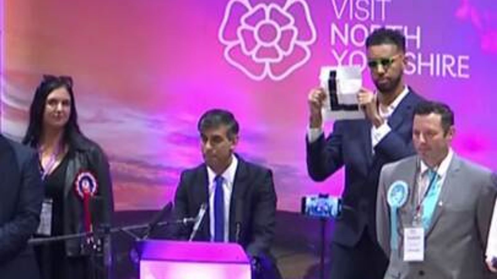 YouTuber holds 'L' sign behind Rishi Sunak | UK News | Sky News