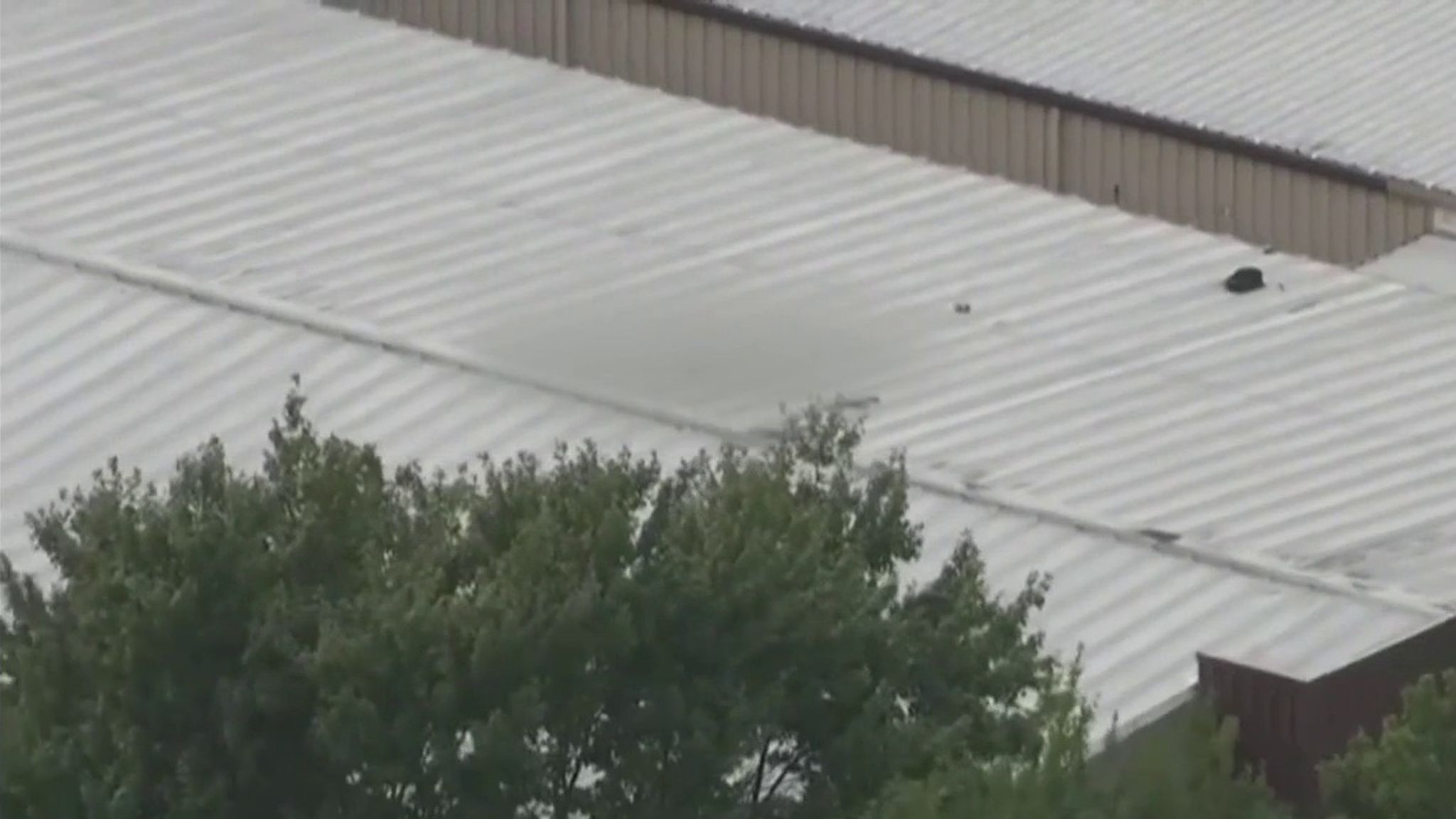 Gunman identified as video shows body and rifle on roof after Trump ...