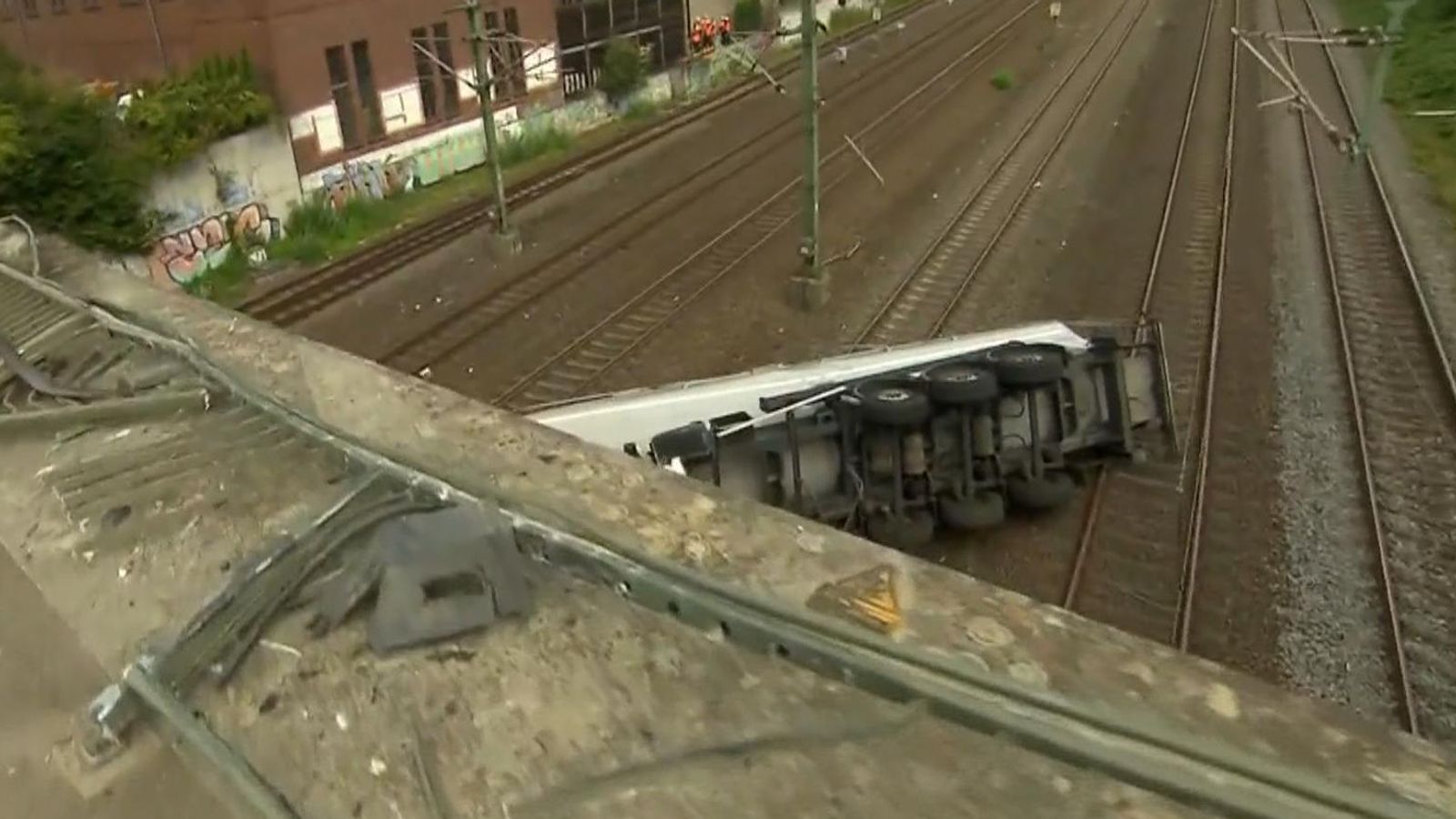 Germany: Police investigate after truck falls from bridge onto railway ...