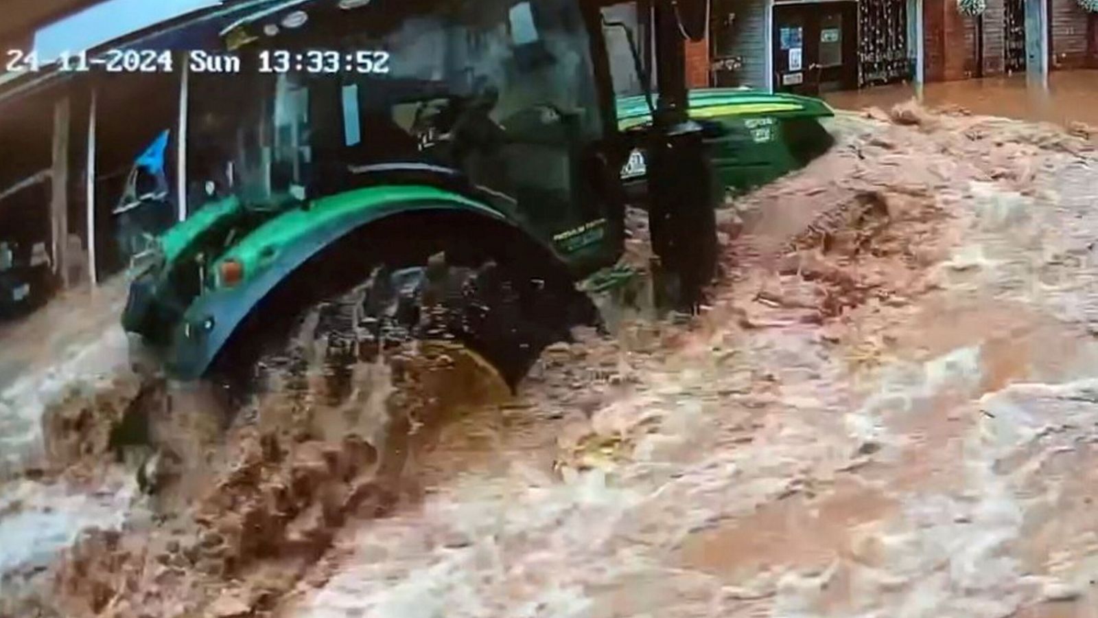 Man arrested after tractor filmed being driven through floodwater ...