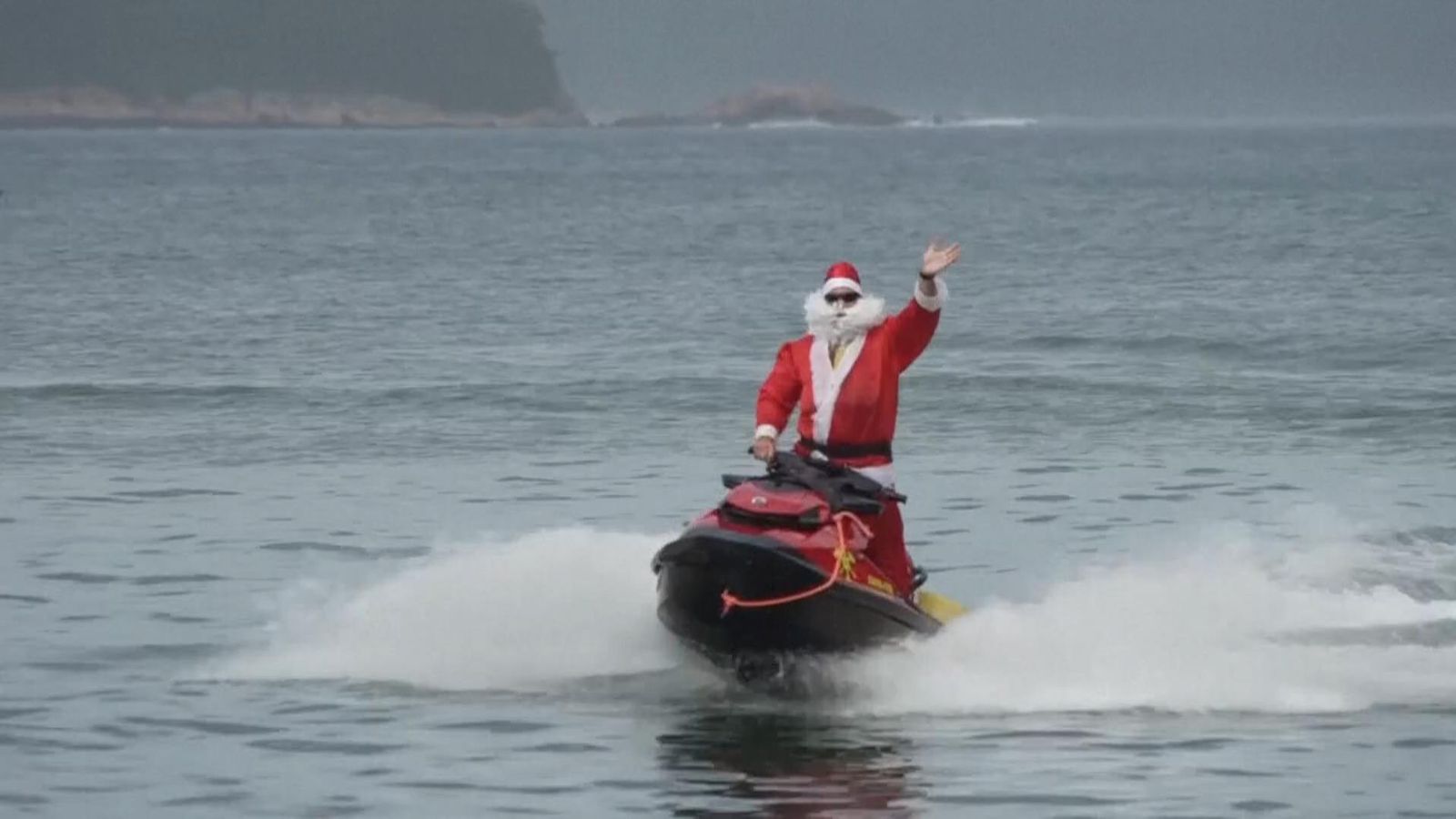 Santa Claus swaps sleigh for jet ski to bring gifts to children in ...