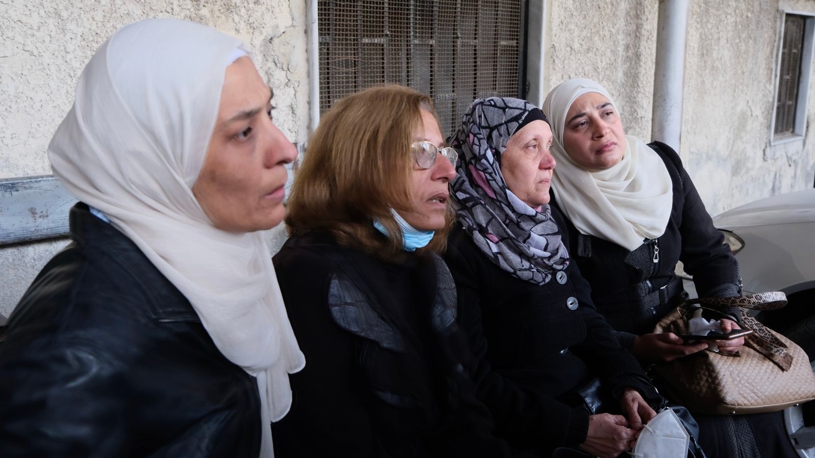 Desperate families look through body bags in search for loved ones in ...