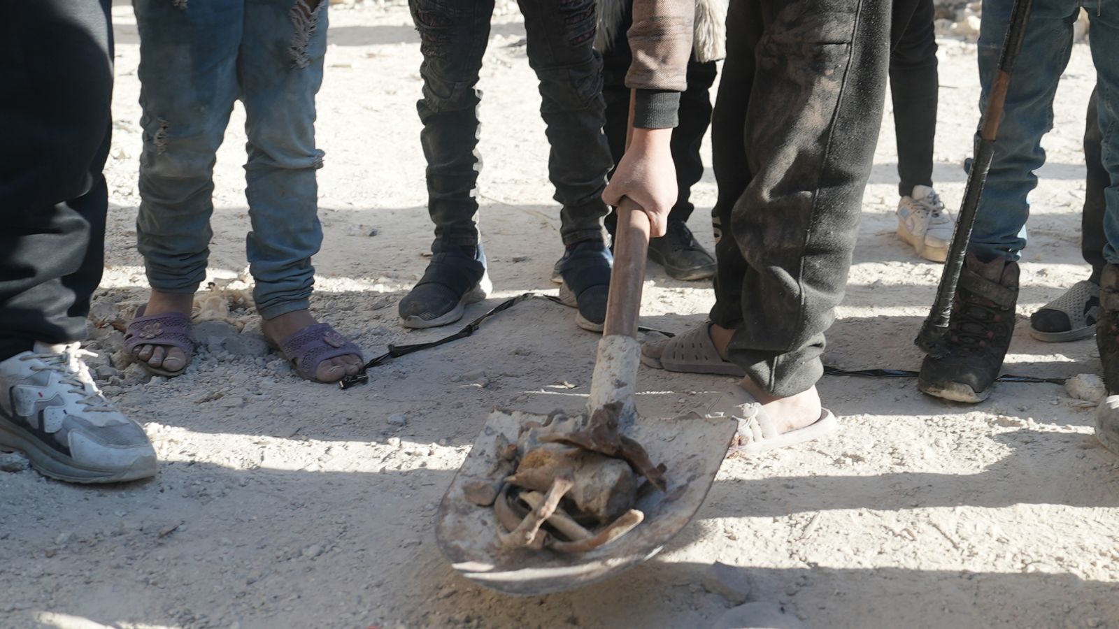 Children dig up bones on street where at least 41 murdered in Syria pit ...
