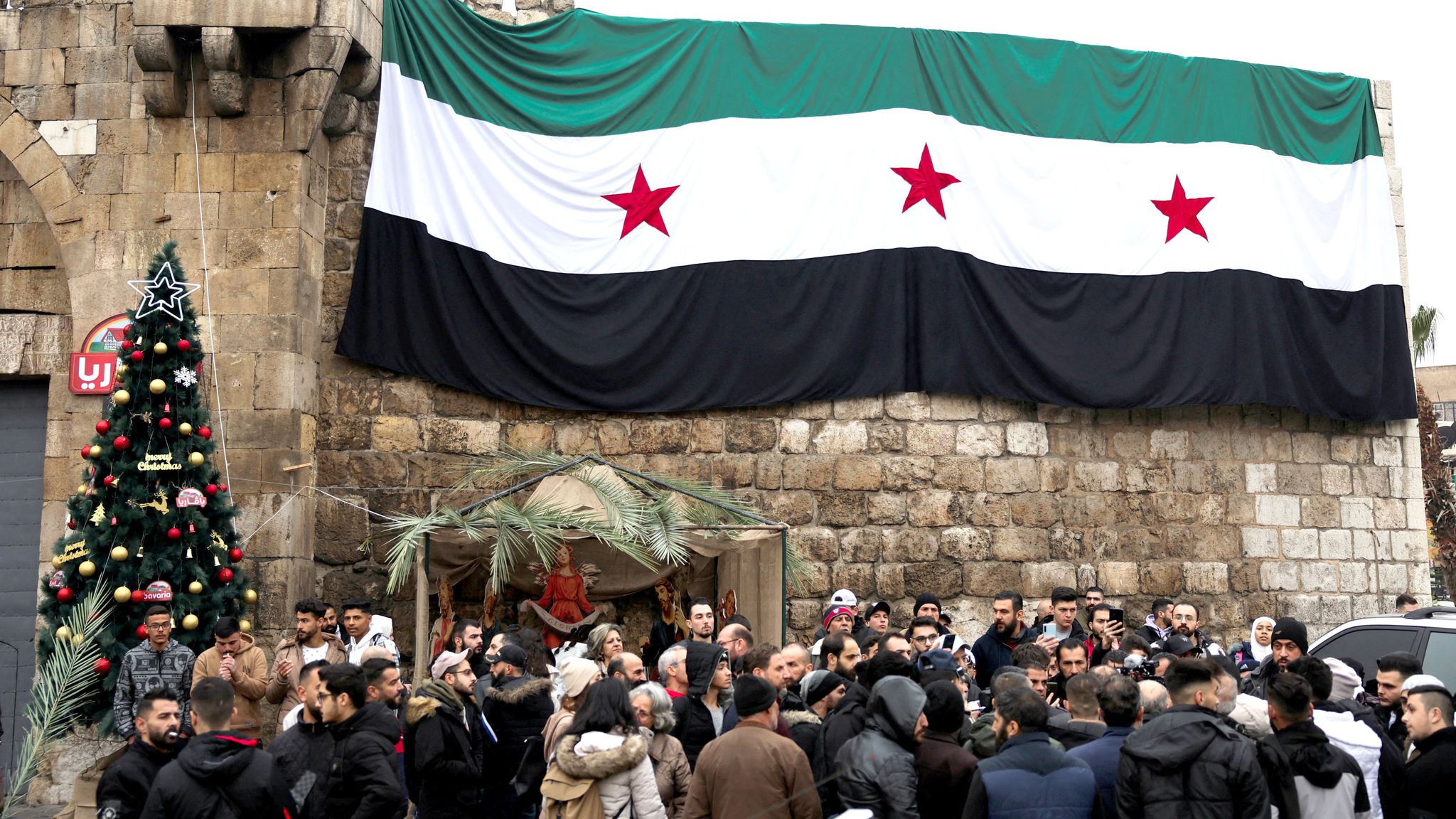 Hundreds protest in Damascus after Syrian Christmas tree set on fire ...