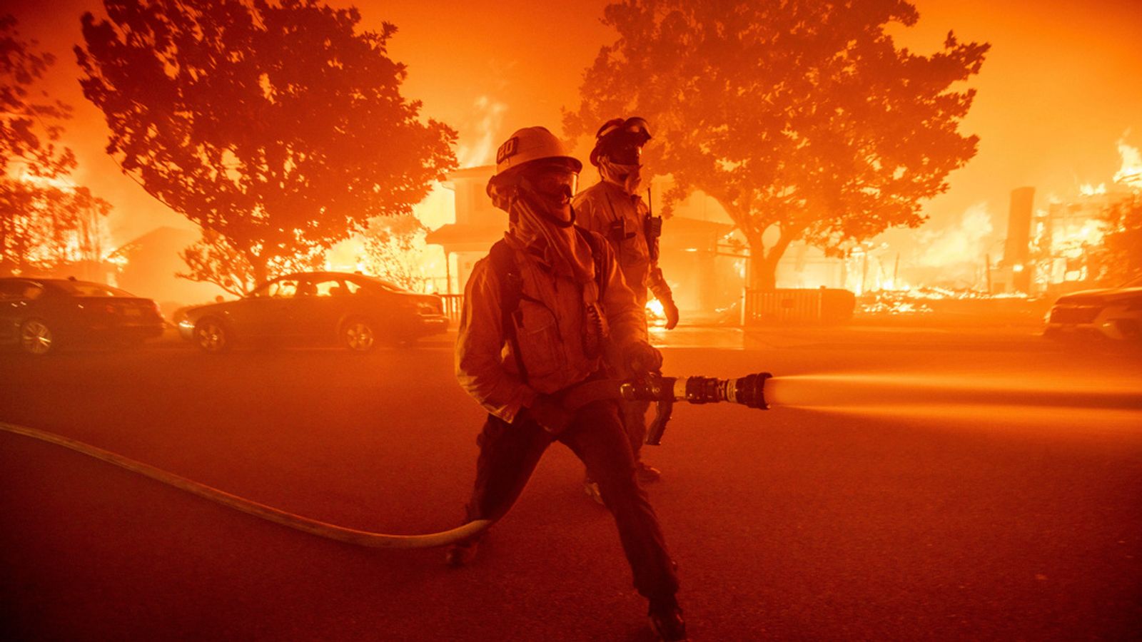 California firefighters battling wildfire sweeping exclusive Los Angeles hillside dotted with ...