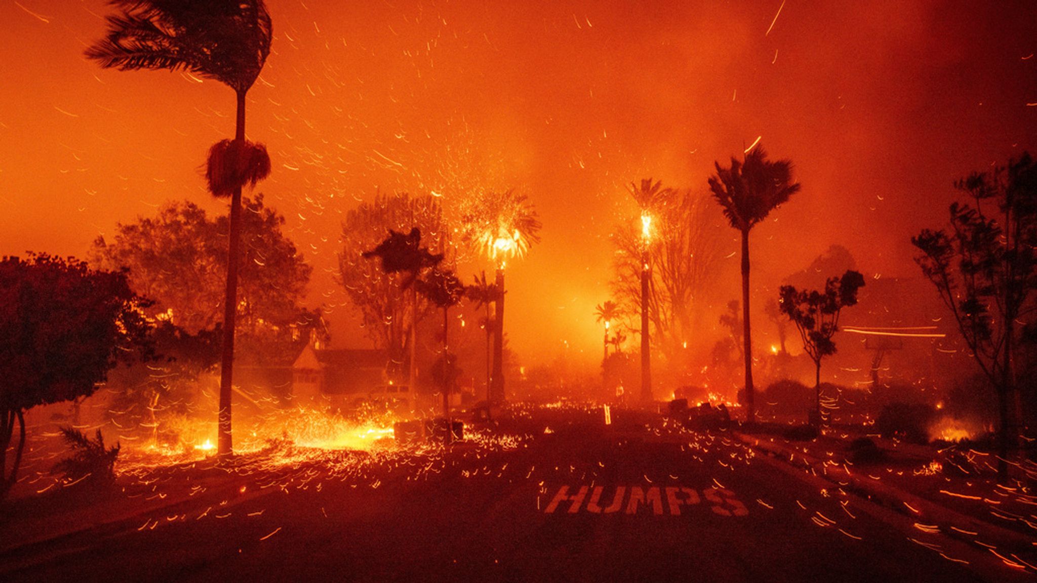California firefighters battling wildfire sweeping exclusive Los ...