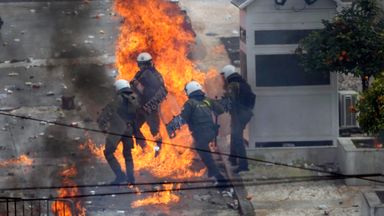 Protesters hurl petrol bombs and police fire tear gas as demonstration ...
