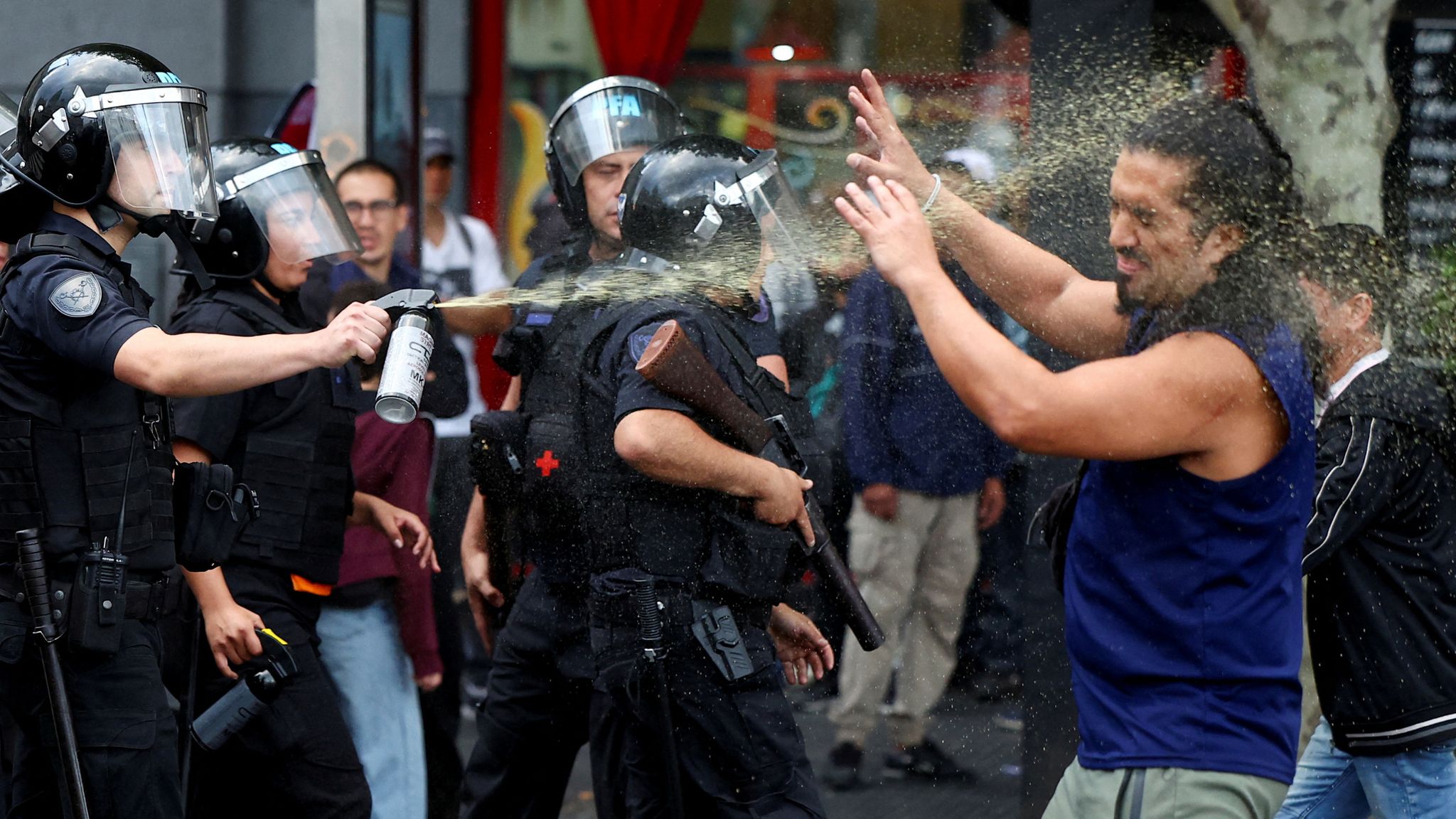 Football fans join with pensioners to clash with police in protest at ...