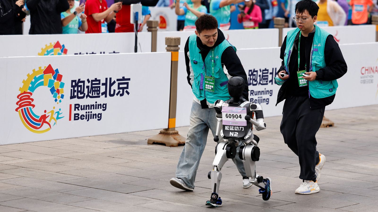 China hosts world's first half-marathon race between humans and robots ...