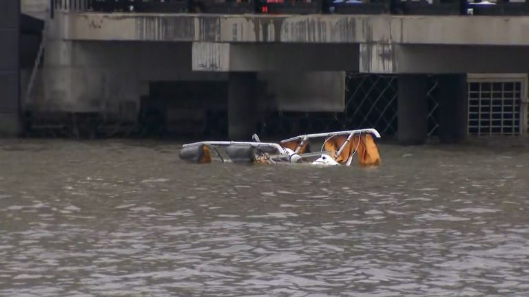Ballerina gracefully dances on top of ship's bow surrounded by ...