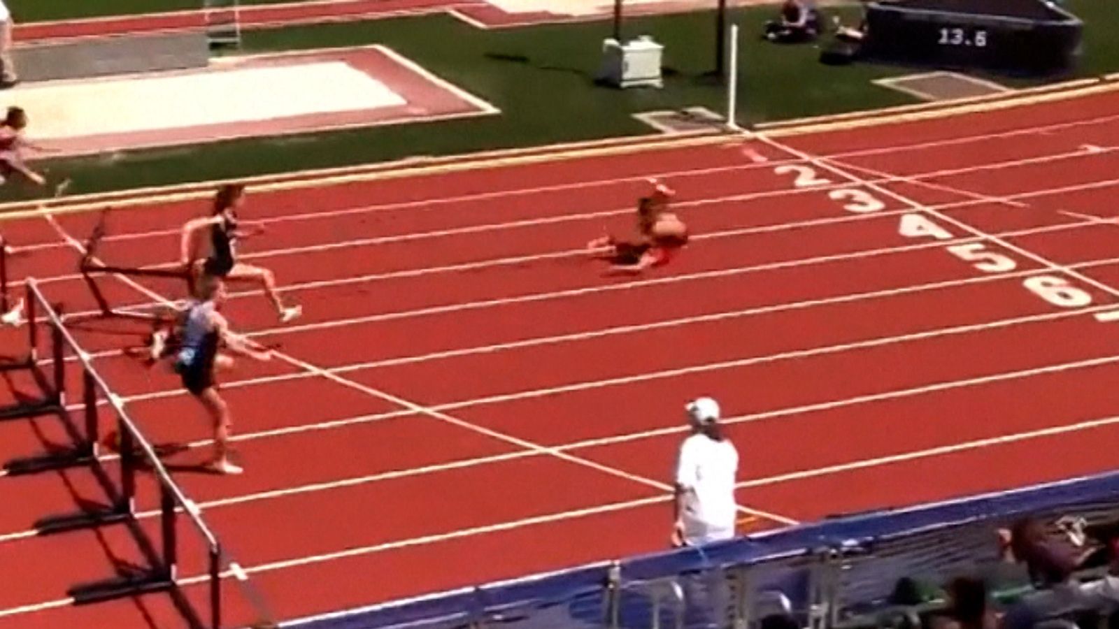Moment hurdler somersaults over finish line to win race | US News | Sky ...