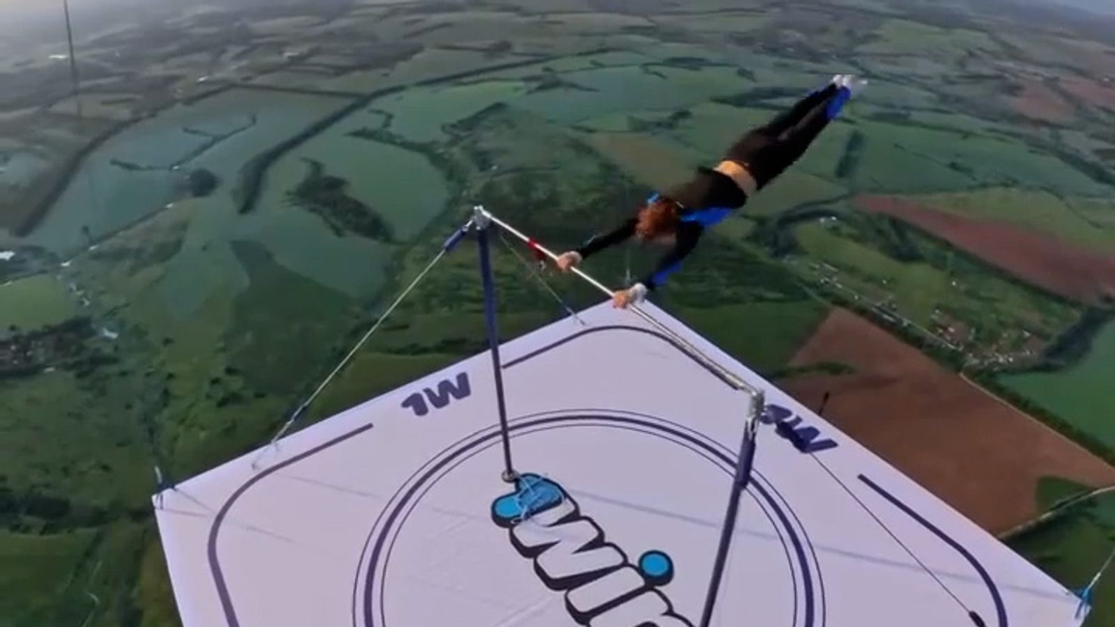 Russian daredevil performs gymnastics hanging under hot air balloon | World News | Sky News