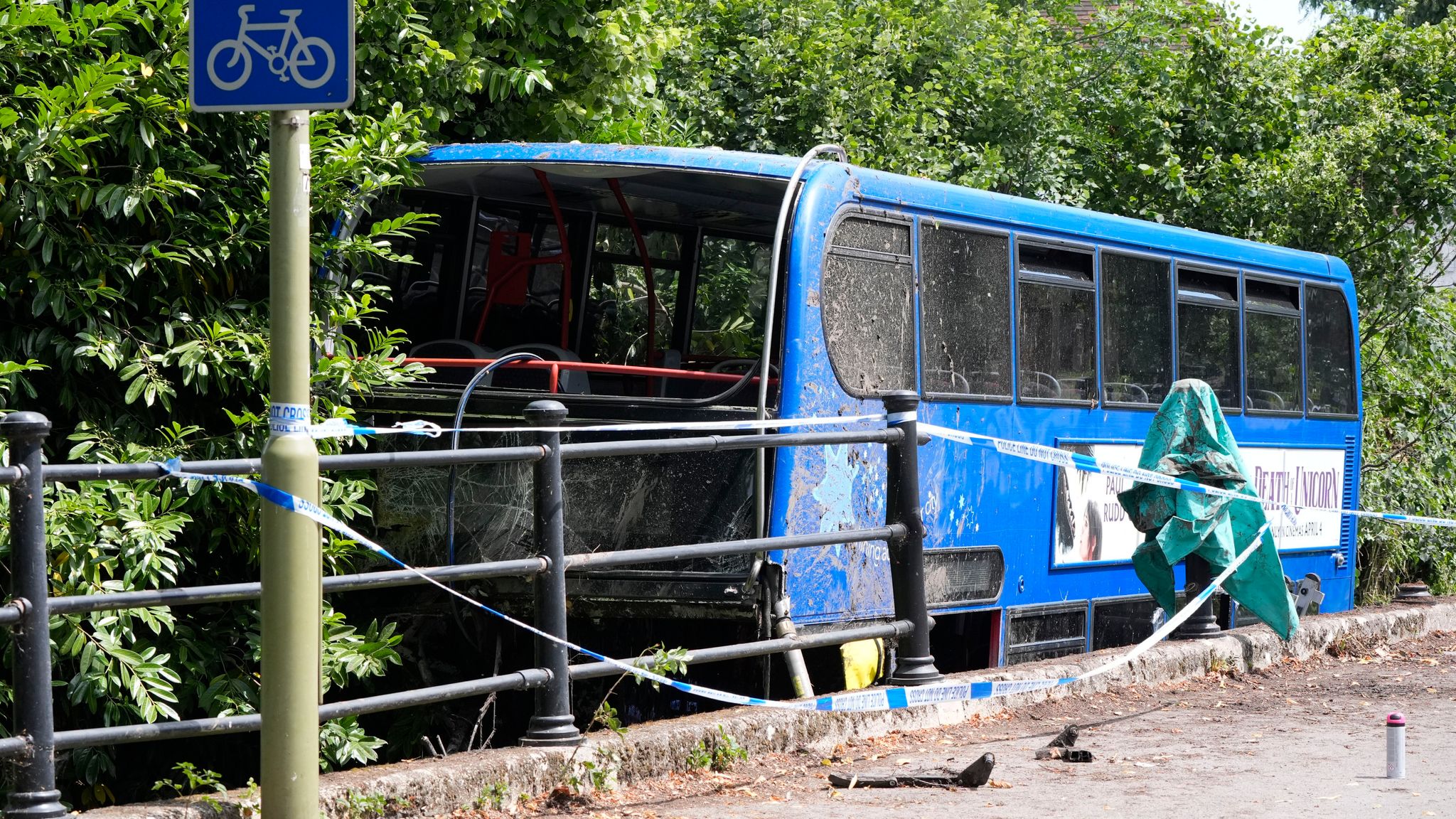 Five people taken to hospital after double-decker bus carrying students crashes into river in ...