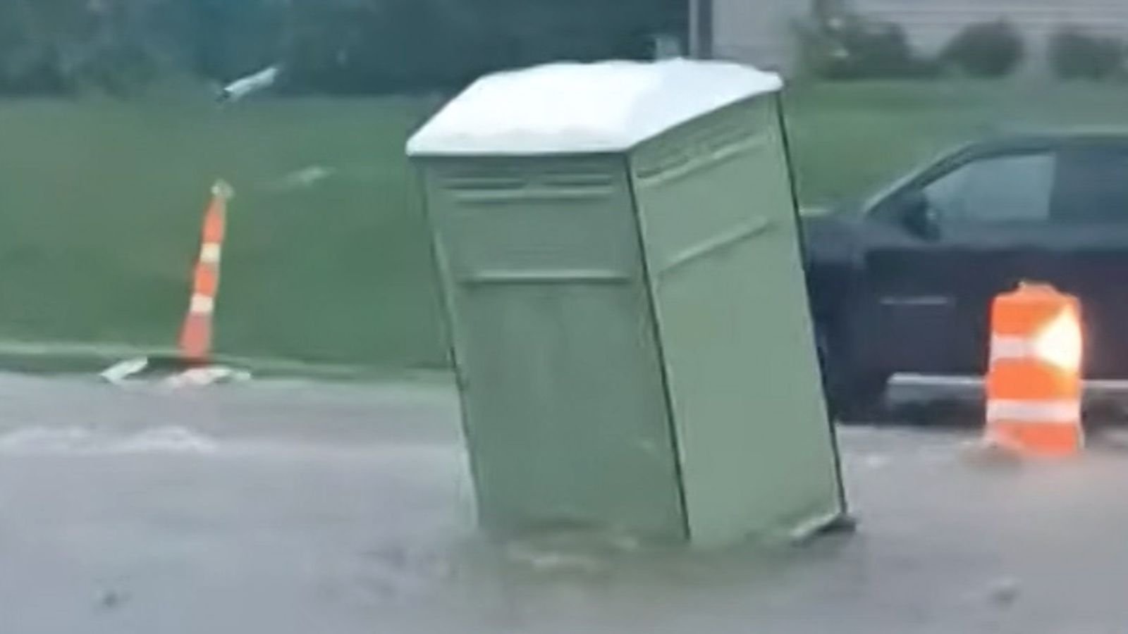 A portable toilet was spotted being washed away down a residential ...