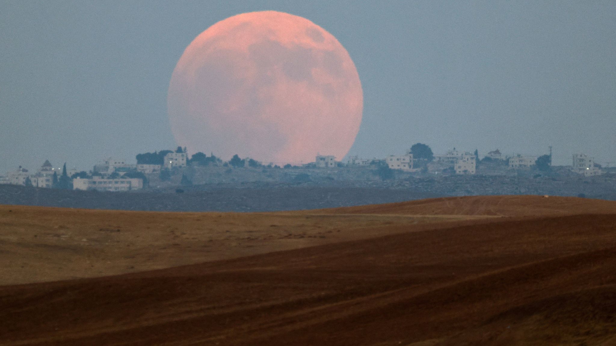 'Blood moon' captured in photos across the world | World News | Sky News