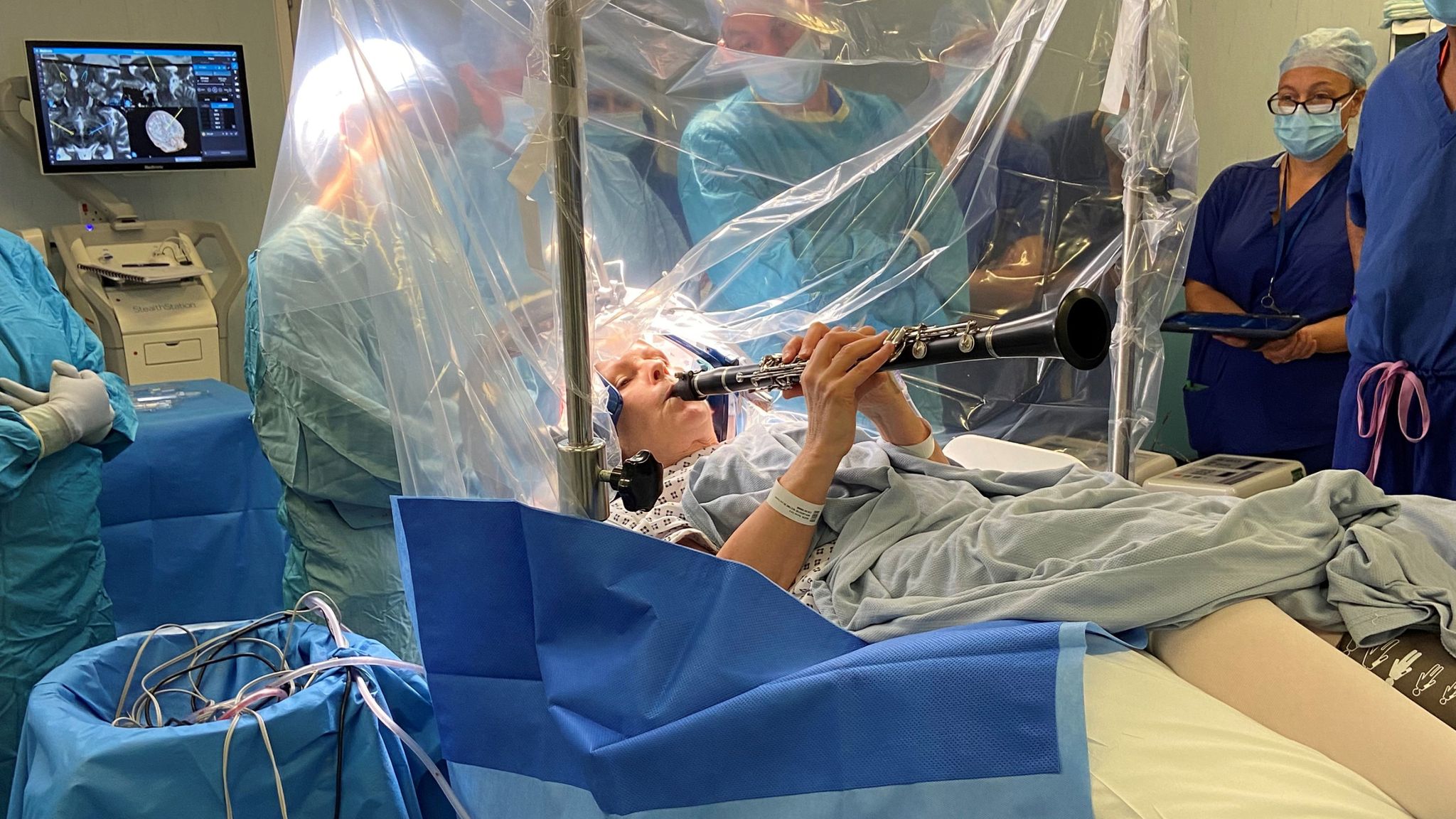 Parkinson's patient plays clarinet during brain surgery | UK News | Sky ...