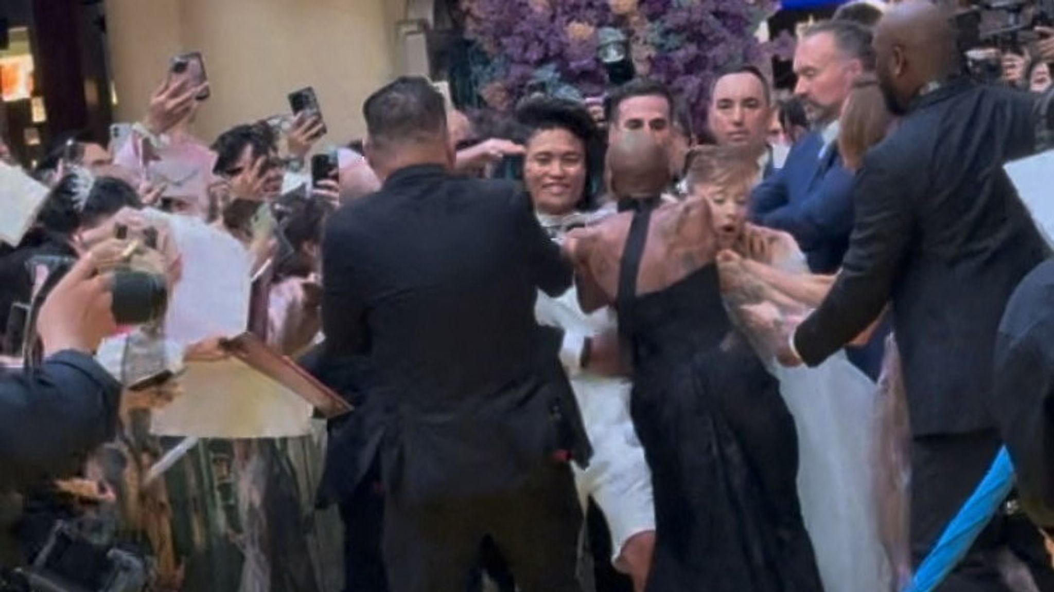 Ariana Grande rushed by red carpet intruder at premiere of Wicked: For ...