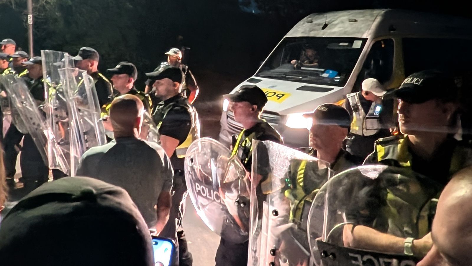 Clashes between police and protesters after small boat arrival | UK ...